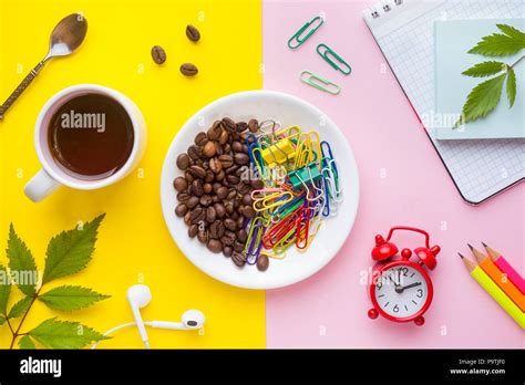 Business Concept Notebook And Stationery With Coffee Cup And Clock On Yellow And Pink