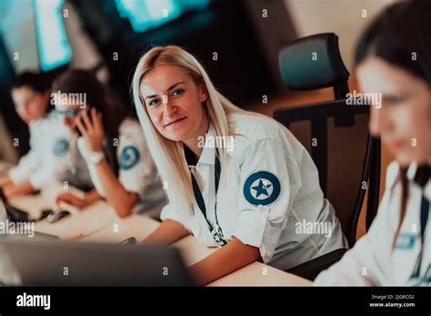 Female Security Operator Working In A Data System Control Room Offices