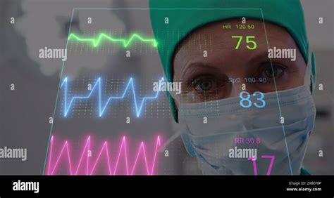 Image Of Interface With Medical Data Processing Over Caucasian Female Surgeon At Hospital Stock