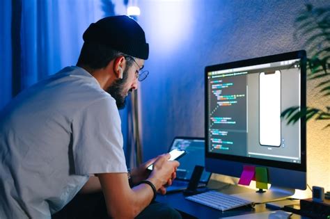 Premium Photo Young Man Mobile Developer Writes Program Code On A