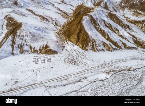 The Gravel Road On Dry Land With The Snow Mountain Stock Photo Alamy