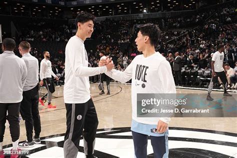 Cui Yongxi Of The Brooklyn Nets Greets Yuki Kawamura Of The Memphis