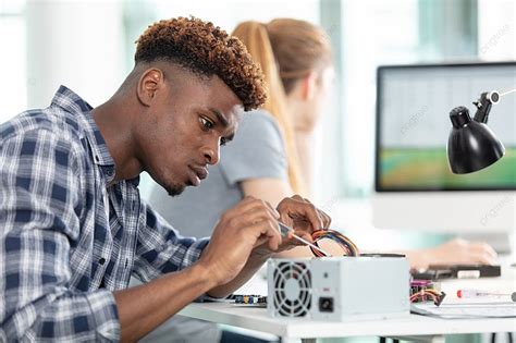 Man And Woman Repairing Computer Motherboard In Workshop Photo Background And Picture For Free