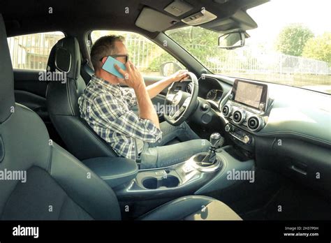 Man Drive A Car And Use Infotainment Driver Male Reading Messages And