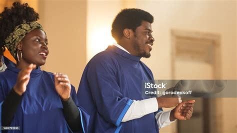 Portrait Of Cheerful African American Man In Blue Robe In Sunday Church