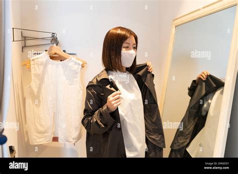 Woman Changing Clothes In Fitting Room Stock Photo Alamy