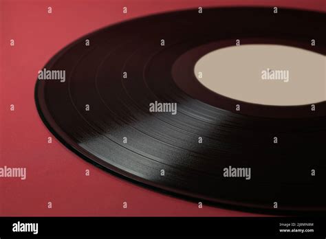 Classic Vinyl Record Close Up On A Red Burgundy Background Outdated