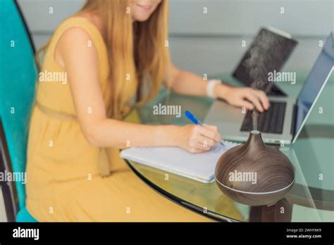 Expectant Woman Enhances Work Environment Using An Aroma Diffuser For A Soothing Atmosphere