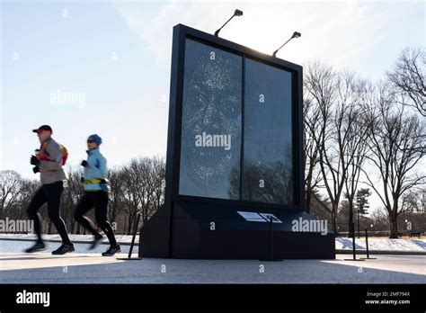 Joggers Pass Behind The Installation Vice President Kamala Harris