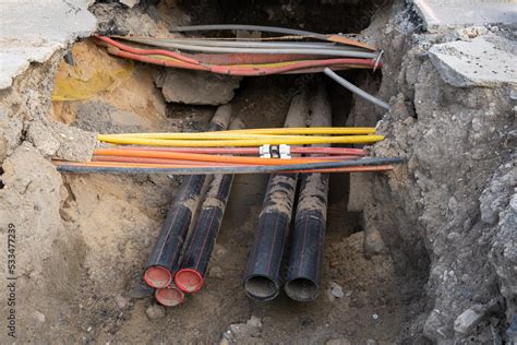 Network Cables In Red Corrugated Pipe Are Buried Underground On The