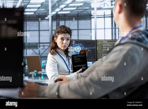 Programmers Using Tablet In Data Center Coordinating Deployment Of