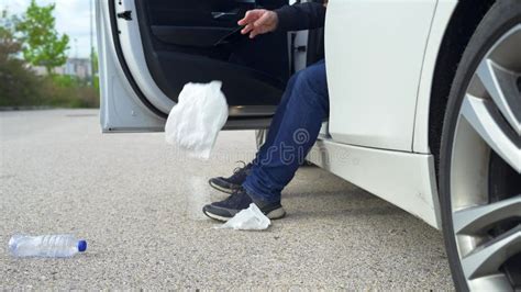 Man Sitting In A Car And Throwing Garbage On The Road Dirtying The Environment Stock Footage