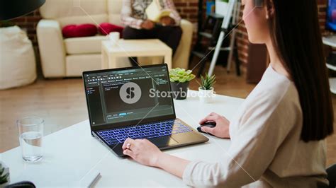 Asian Female Programmer Works On Coding Software In A Home Office Setup Typing Code On A Laptop