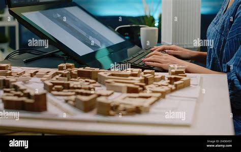 Close Up Of Building Model On Table And Woman Using Touch Screen