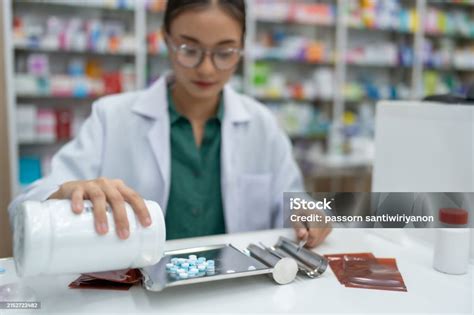 A Pharmacist Is Sorting Different Types Of Medicines Before Giving It