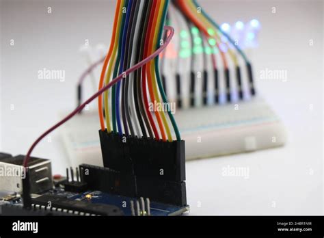 Set Of Jumper Wires Connected To A Microcontroller Board That Completes Set Of Jumper Wires Connected To A Microcontroller Board That Completes