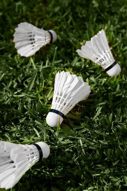 Free Photo Badminton Shuttlecocks And Racket On Grass High Angle