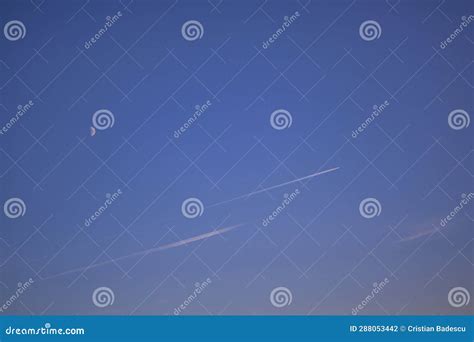 Two Passenger Planes Passing Parallel In The Blue Sky Traces Made By