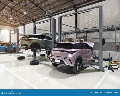A Car Is Raised Up Using A Lift Inside A Service For Maintenance Stock