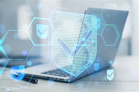 Close Up Of Laptop Computer At Desk With Glowing Hexagonal Shield