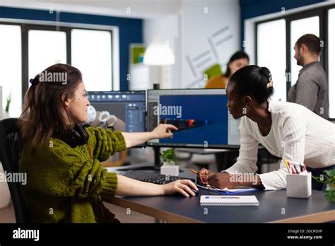 Diverse Women Game Developers Creating Game Interface Sitting In Startup Creative Production