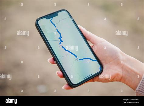 A Close Up Of A Hand Holding A Smartphone Displaying A Gps Navigation