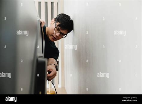 Man Looking Fix Cable Connection Problem Of Tv Panel Back Side Against