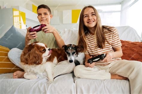 Free Photo Cousins Spending Time Together At Home And Playing Video Games