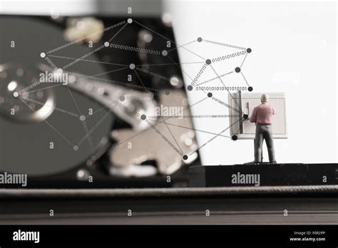 Close Up Of Open Computer Hard Disk Drive With Social Network Diagram On Desk And Notebook Stock