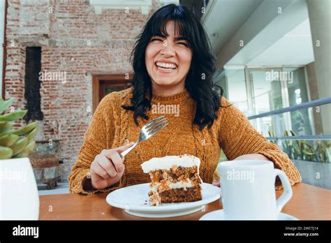 Portrait Of Young Latin Woman With Black Hair And Brown Sweater