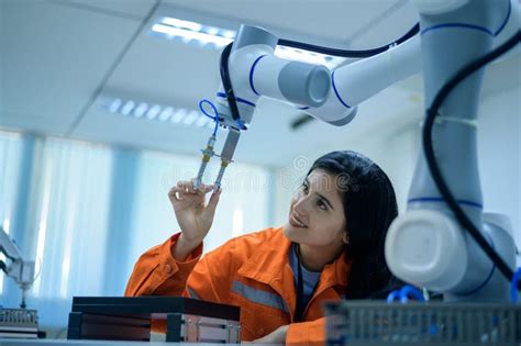 female robotics engineer working with programming and manipulating
