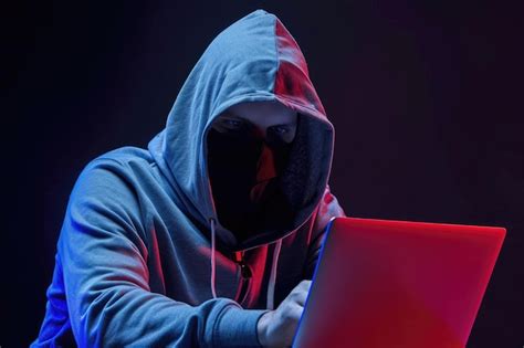 Premium Photo A Mysterious Hacker Wearing A Mask And Hoodie Working