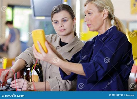 Two Female Electricians Measuring Voltage Stock Image Image Of Stepladder Setup