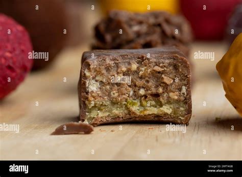 Different Chocolates Without Packaging Lying On A Wooden Board