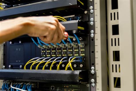 Premium Photo Man Connecting Network Cable To Switch
