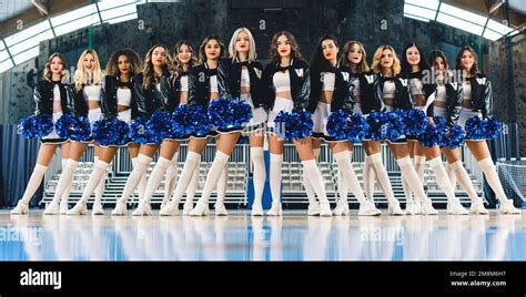 Cheerleaders In Mini Skirts Captured At A Low Angle While Standing With