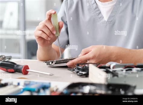 Hands Of Female Troubleshooting Technician Fixing Tiny Details Of Computer Hardware While