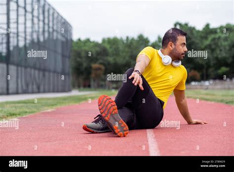 Athlete Man In Urban Sports Arena Practices Flexibility Performing
