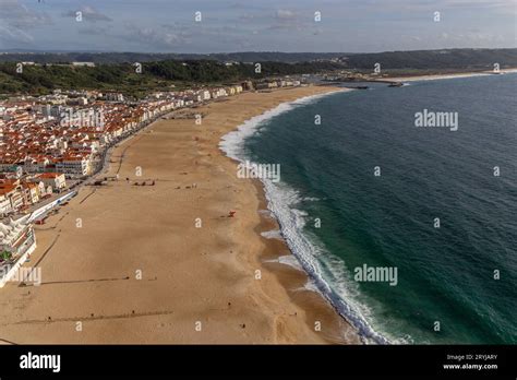 Tourists And Visitors To The Windy Surfing Beaches Of Nazare In