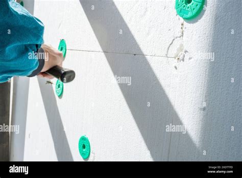 Builder Installing Rigid Styrofoam Insulation Board For Energy Saving Close Up Rigid Extruded