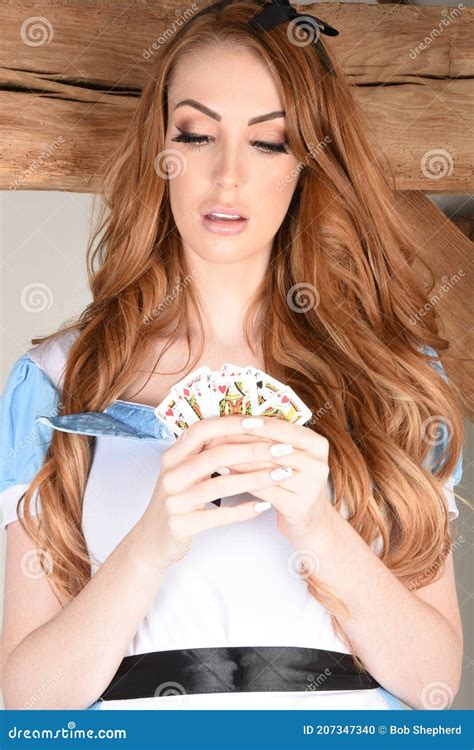 Tall Slim Attractive Redhead Model Dressed As A Fantasy Alice In Wonderland Stock Photo