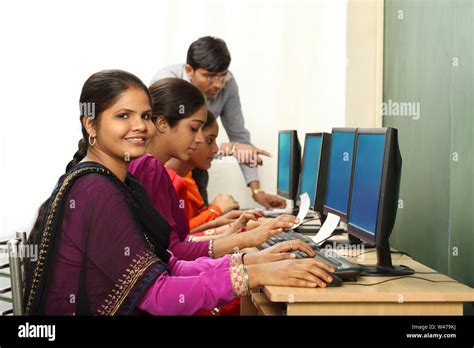 Women Using Computers With Teacher Assistance Stock Photo Alamy