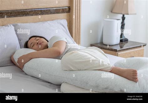 Close Up View Of A Pregnant Woman Sleeping On The Bed With The