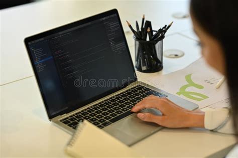 cropped shot of female developer working with coded data on computer screen at her office stock