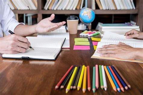 Premium Photo Student Campus Or Classmates Help Friend Catching Up Workbook And Learning