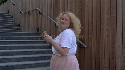 A Plump Caucasian Woman Eats An Ice Cream Cone While Walking Stock Footage Video Of Food
