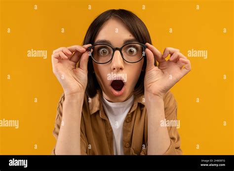 Unbelievable Shocked Caucasian Lady Touching Glasses And Looking At