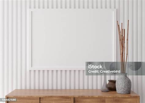 현대 거실의 흰색 벽에 빈 그림 프레임 미니멀한 스칸디나비아 스타일로 인테리어를 모의하세요 당신의 그림을위한 여유 공간 말린 식물이있는 나무 콘솔과 화병 3d 렌더링 0명에