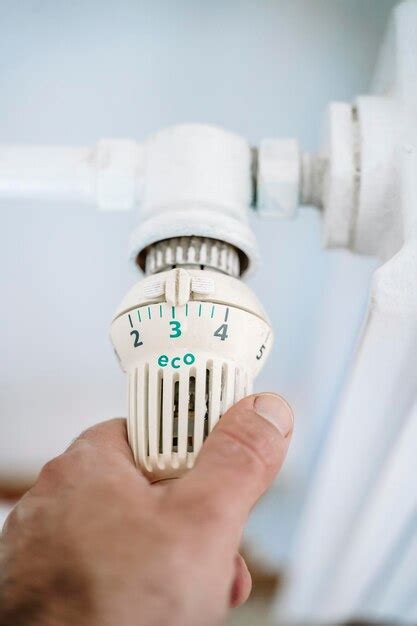 Radiator Thermostat And Hand Heating House In Winter Savings On Heating