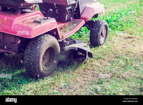 Fresh Cut Grass Flying From Riding Lawnmower Person Cutting Long Green